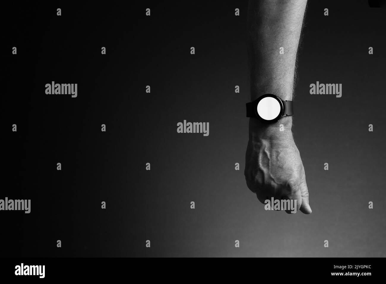 Black and white image of man's hand with smart watch on wrist ...