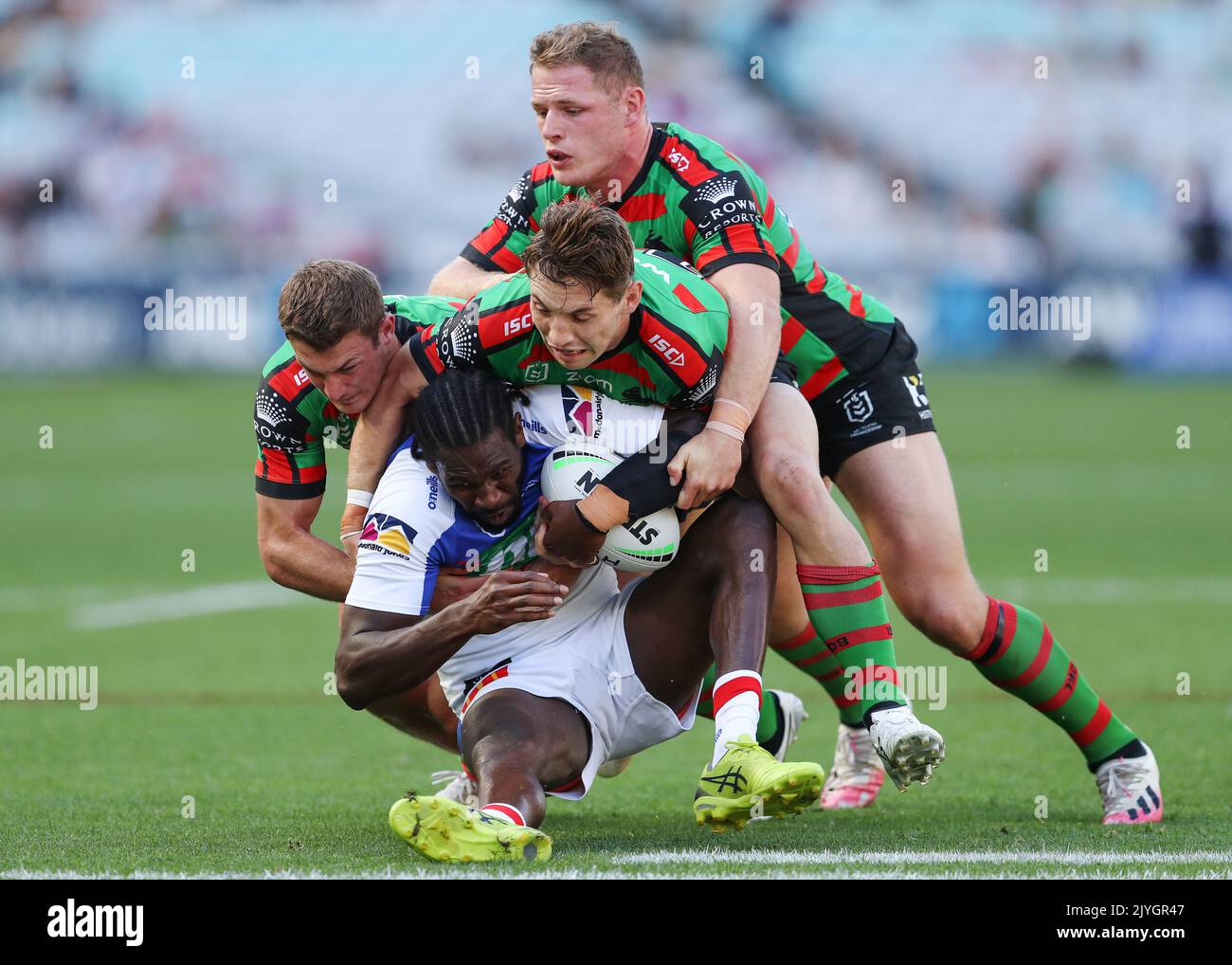Edrick Lee of the Knights is tackled by the Rabbitohs defence during ...
