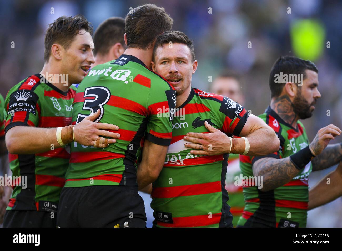 Damien Cook of the Rabbitohs celebrates with team mates after scoring a ...