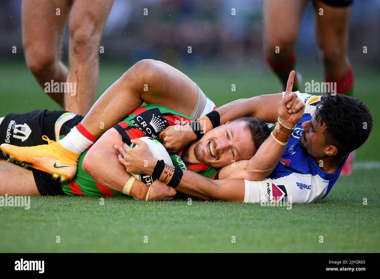 Damien Cook of the Rabbitohs gestures after scoring a try during the ...