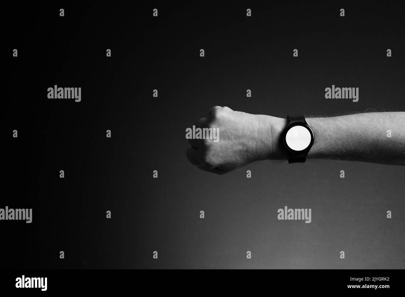 Black and white image of man's hand with smart watch on wrist ...