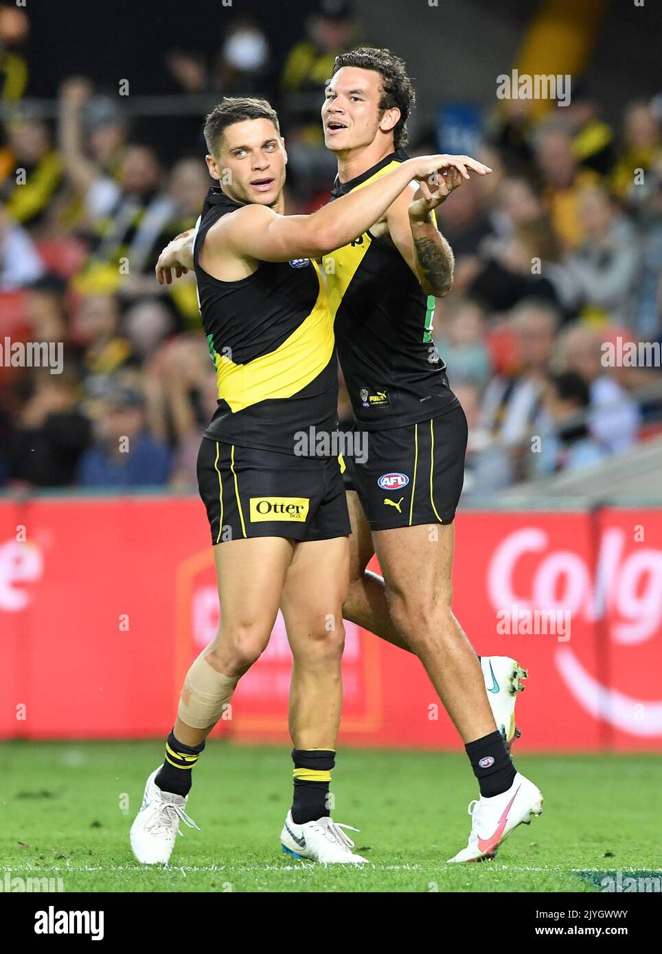 Daniel Rioli of the Tigers (right) reacts with Dion Prestia after ...