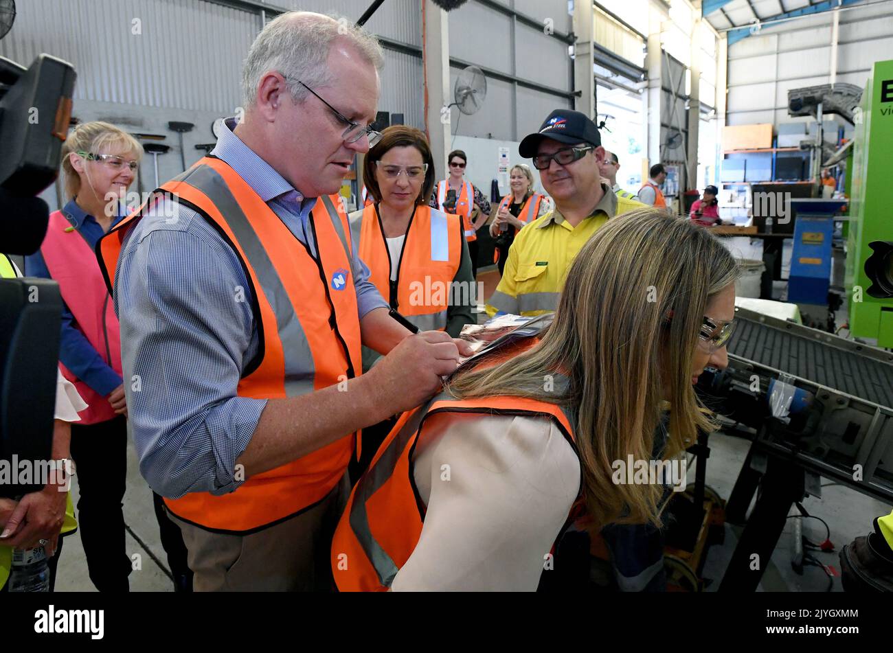 Prime Minister Scott Morrison (left) signs a photograph for steel ...