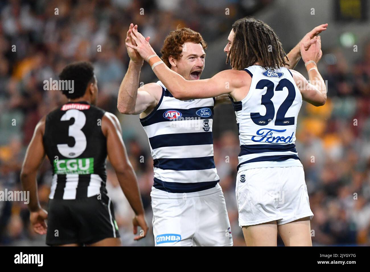 Gryan Miers (right) of the Cats celebrates kicking a goal with Gary ...