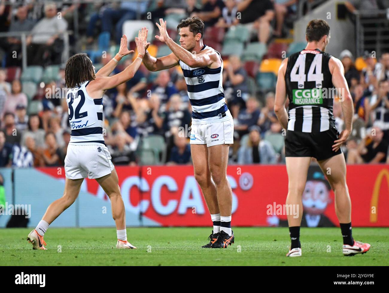 Tom Hawkins (centre) of the Cats celebrates kicking a goal with Gryan ...