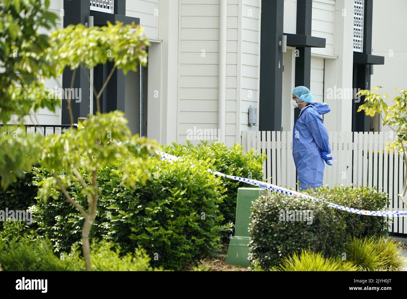 Forensic officers are seen working at a residence in Cox Street in ...