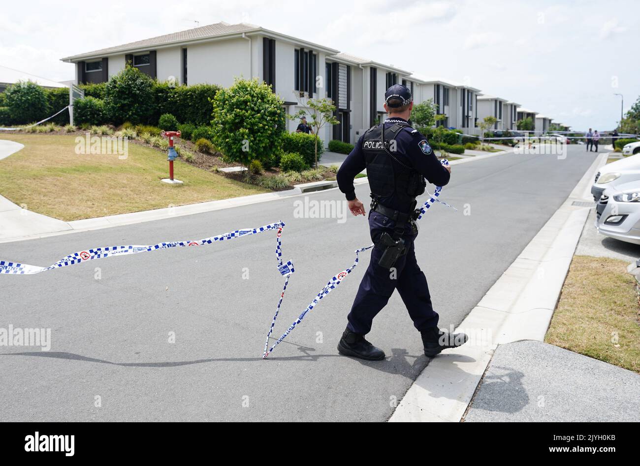 A Police officer closes off Cox Street in Pimpama on the Gold Coast ...