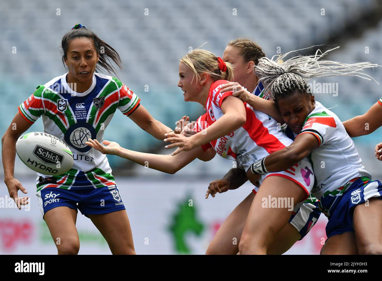 Jaime Chapman of the Dragons off loads as she's tackled by Ellia Green ...