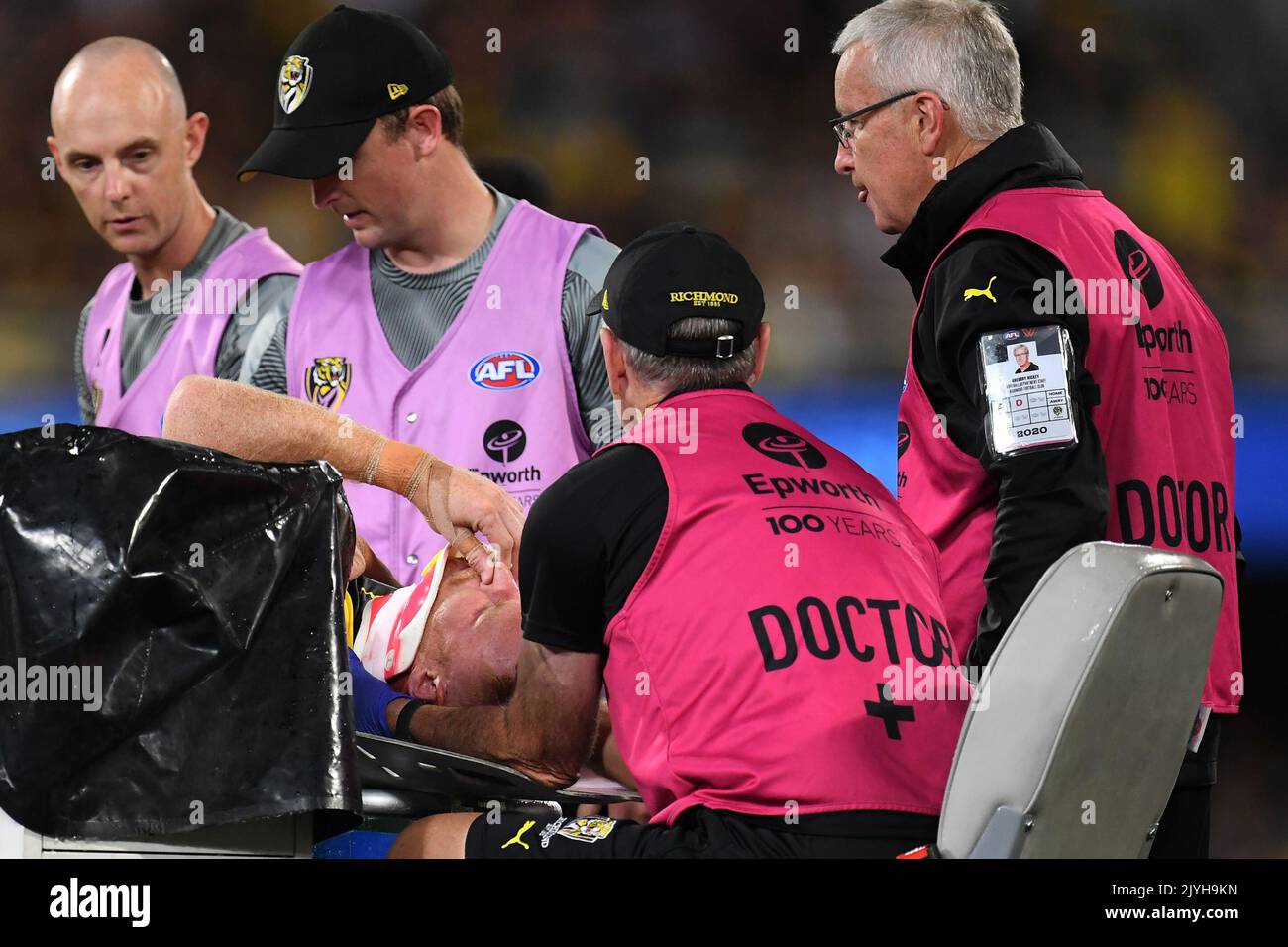 Nick Vlastuin of the Tigers is stretchered off the ground after ...