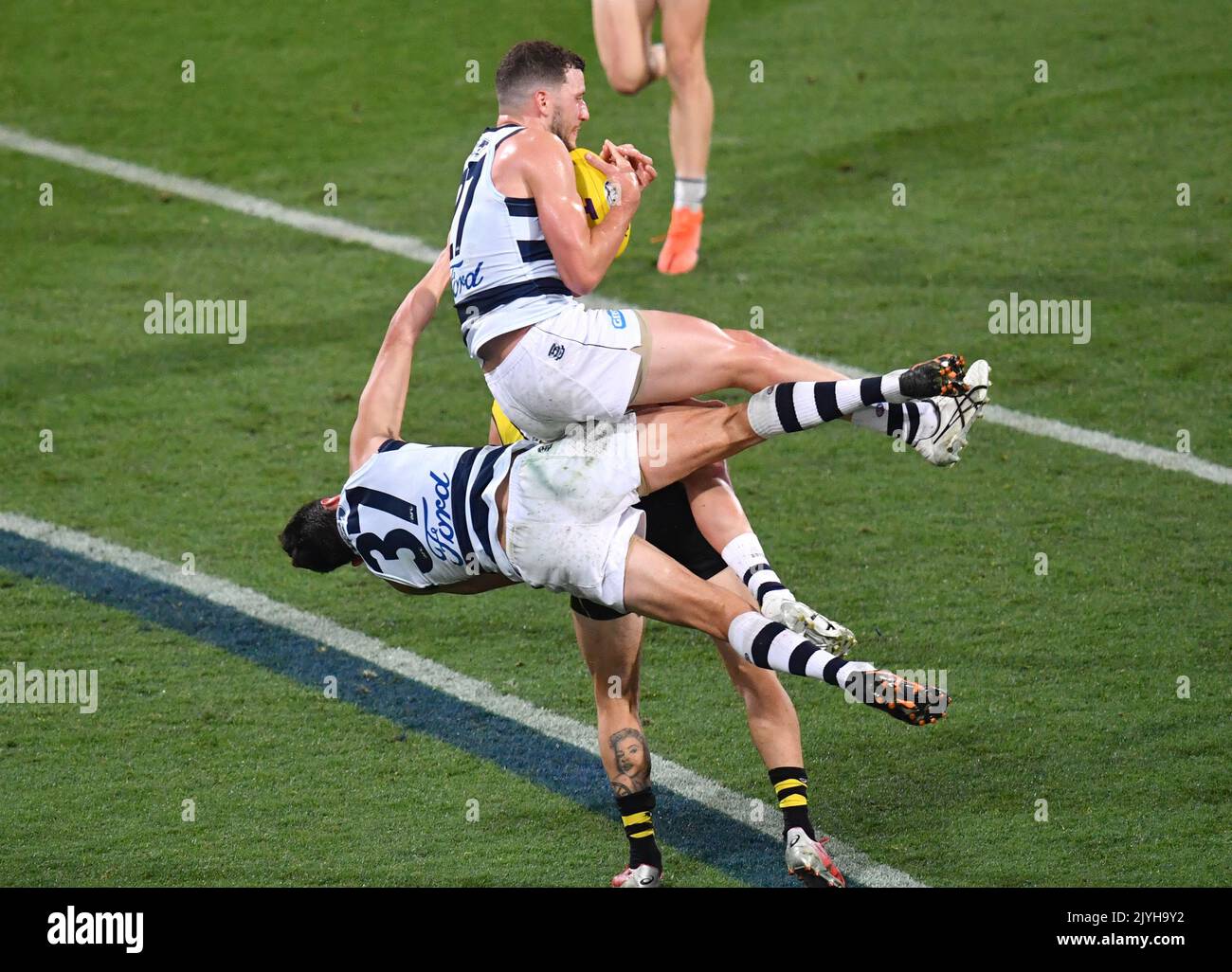 Sam Menegola (top) of the Cats is seen colliding with team mate Sam ...
