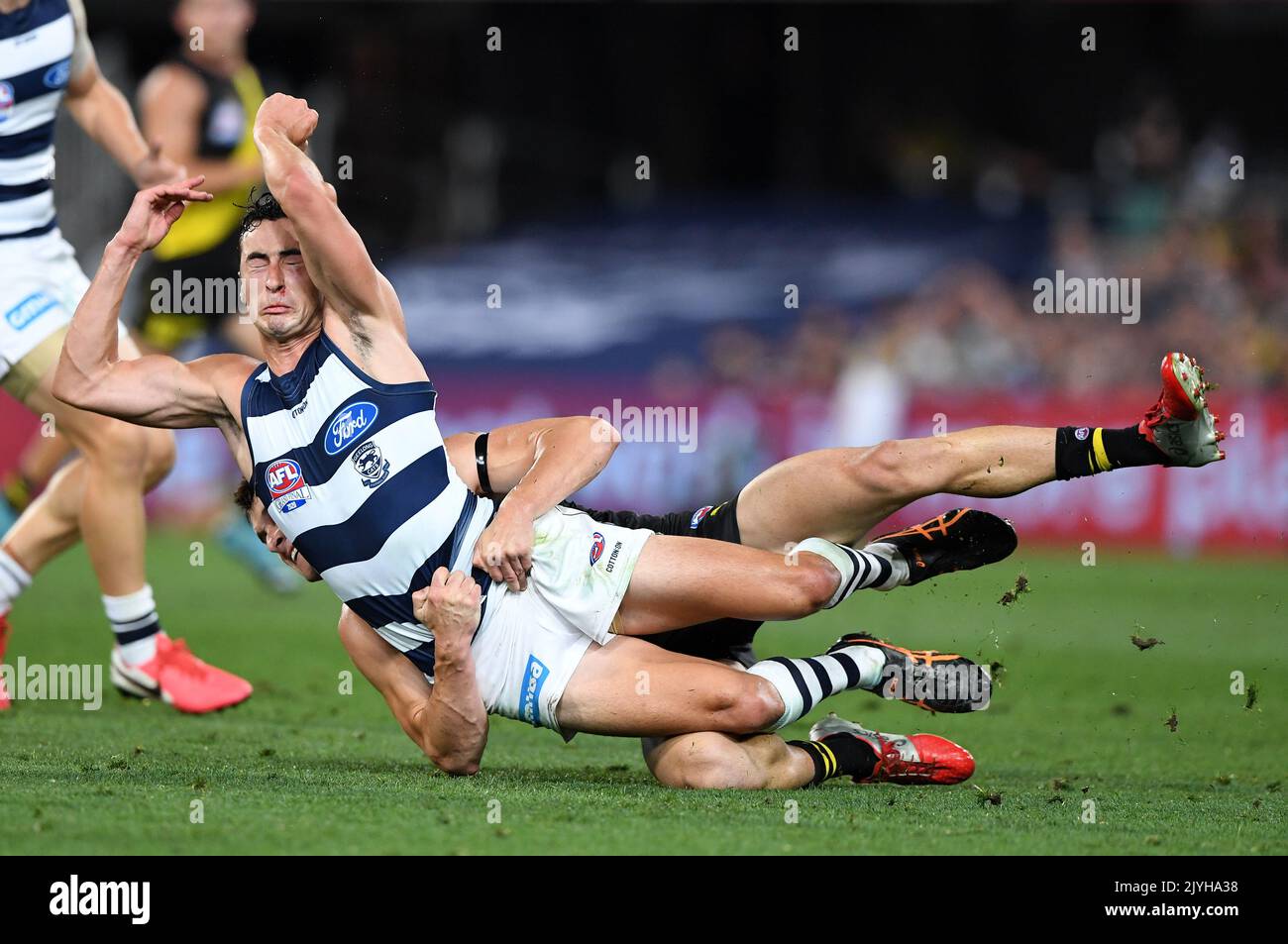 Sam Simpson of the Cats is tackled by Jayden Short of the Tigers during ...
