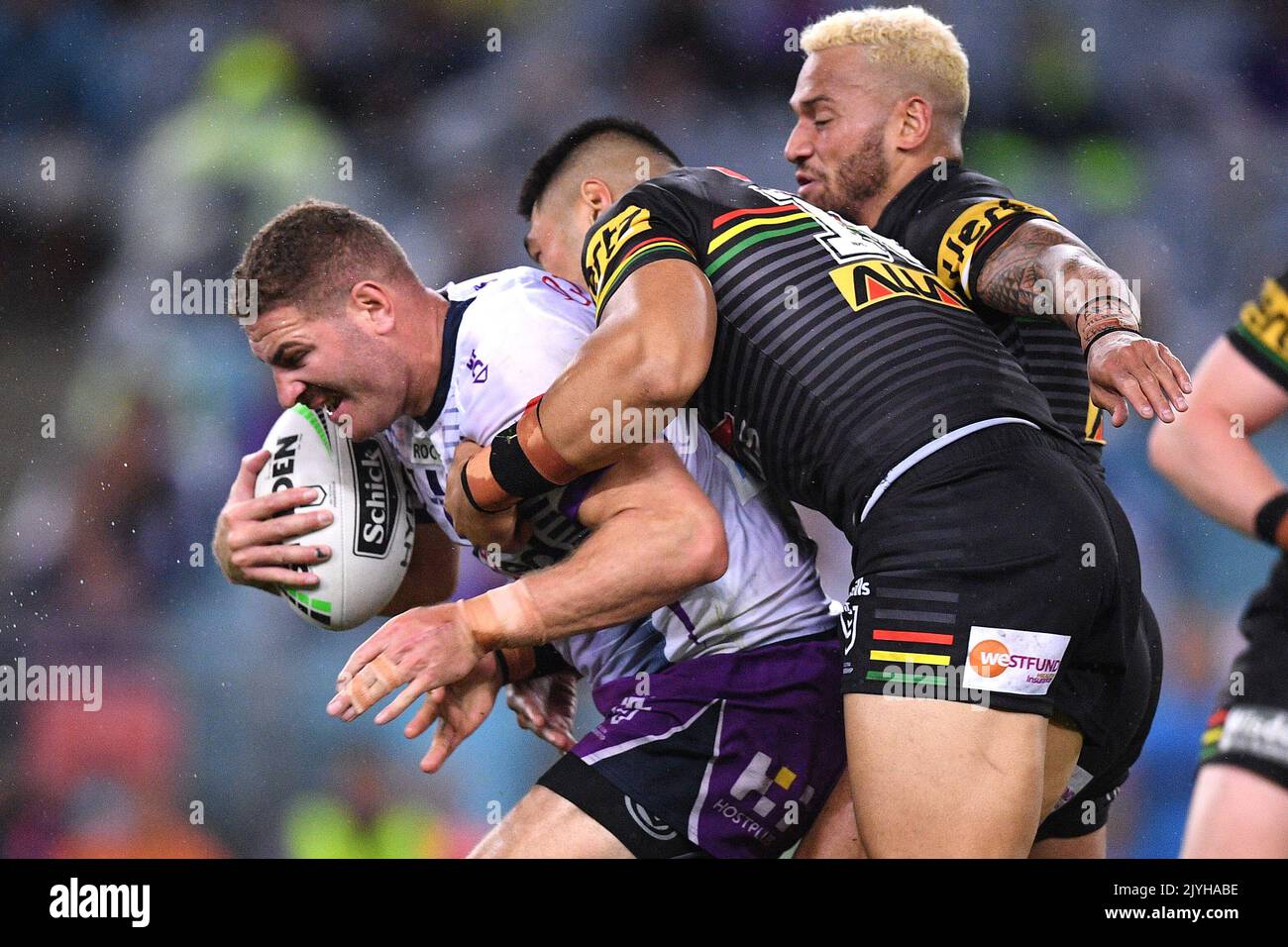 Brenko Lee of the Storm is tackled by Moses Leota of the Panthers ...