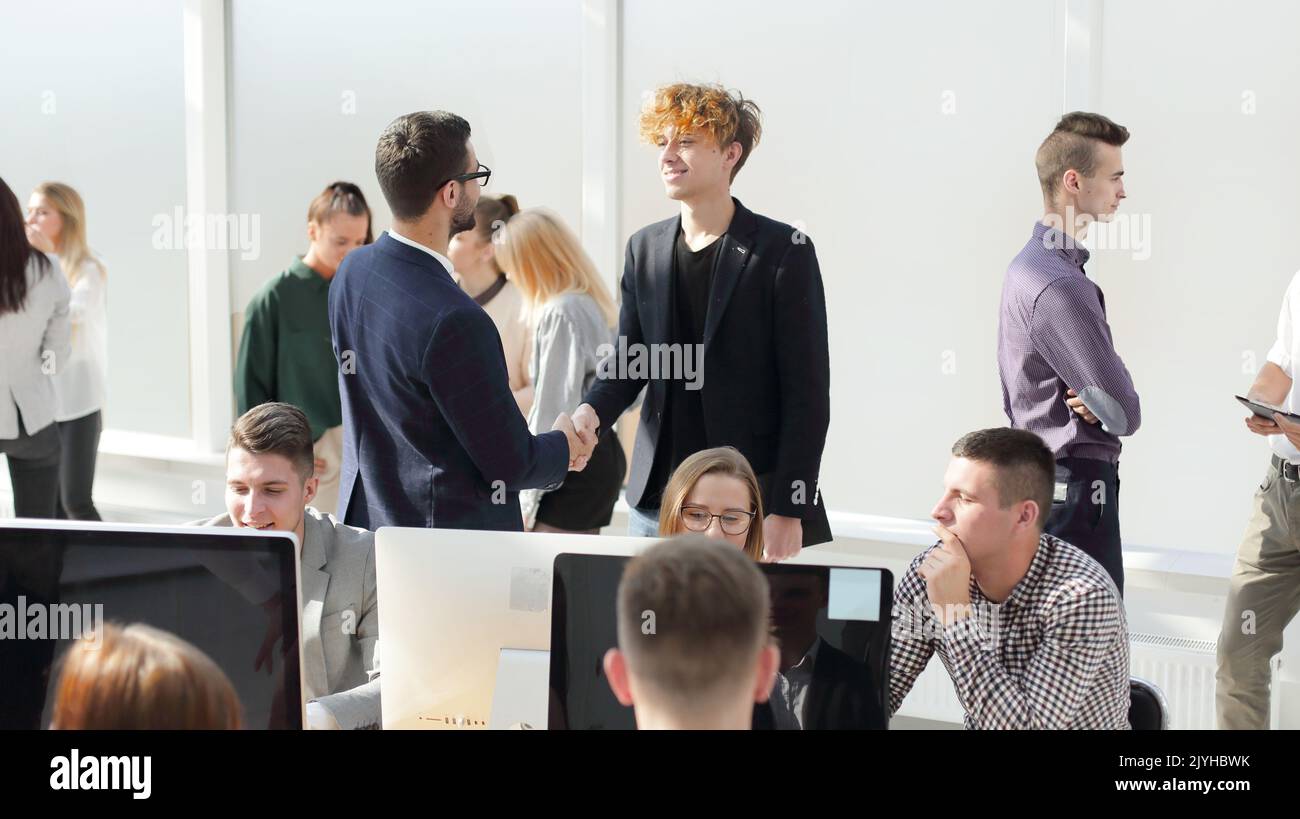 employees discussing work issues in the office Stock Photo - Alamy