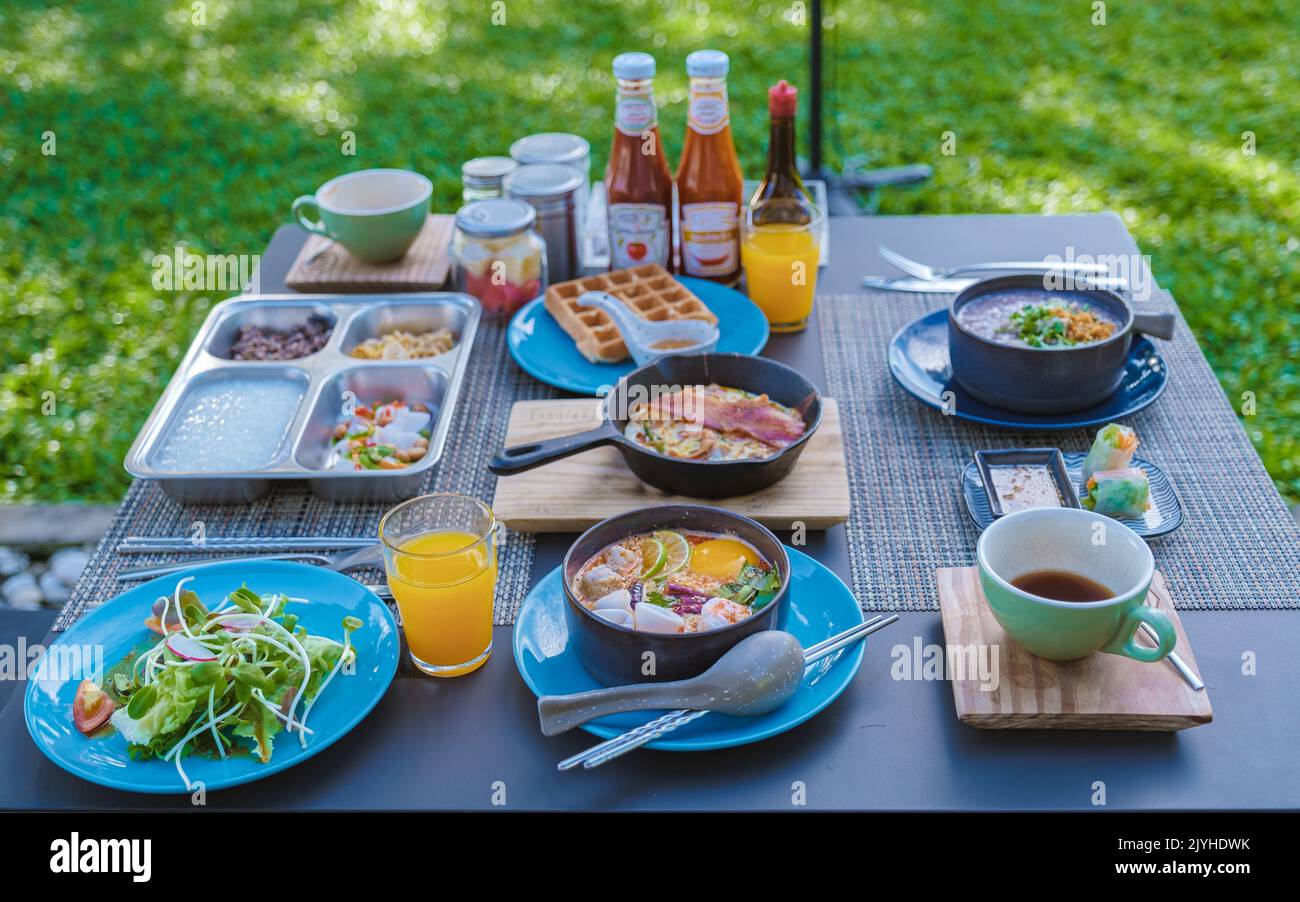 Luxury Asian breakfast on a table by the River Kwai in Thailand ...