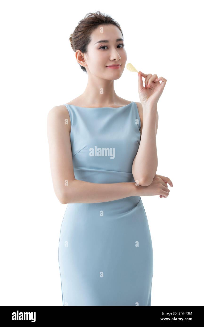 Beautiful young Chinese woman eating potato chip Stock Photo - Alamy