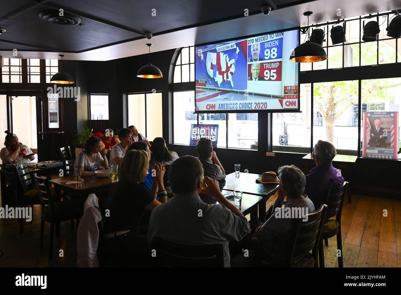 Patrons watch the US election day live results during a US election ...