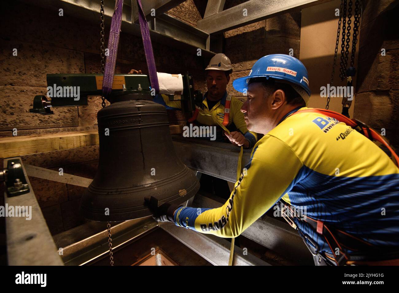 Workers Rick Staats and Brian Zammitt (right) hoist one of eight new ...