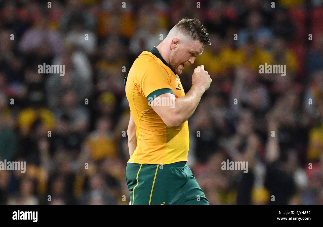 Lachlan Swinton (centre) of the Wallabies is seen reacting after being ...