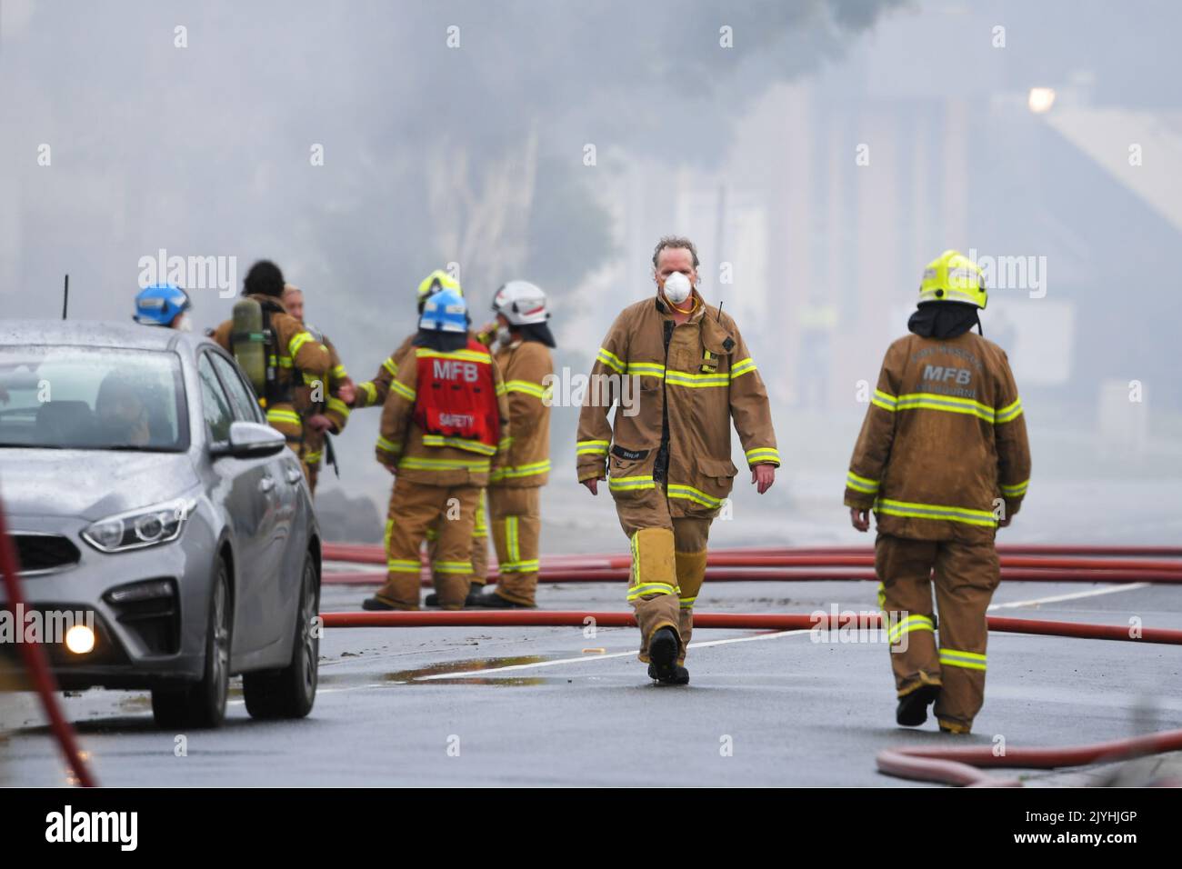 Metropolitan Fire Brigade personnel are seen near a factory fire in ...