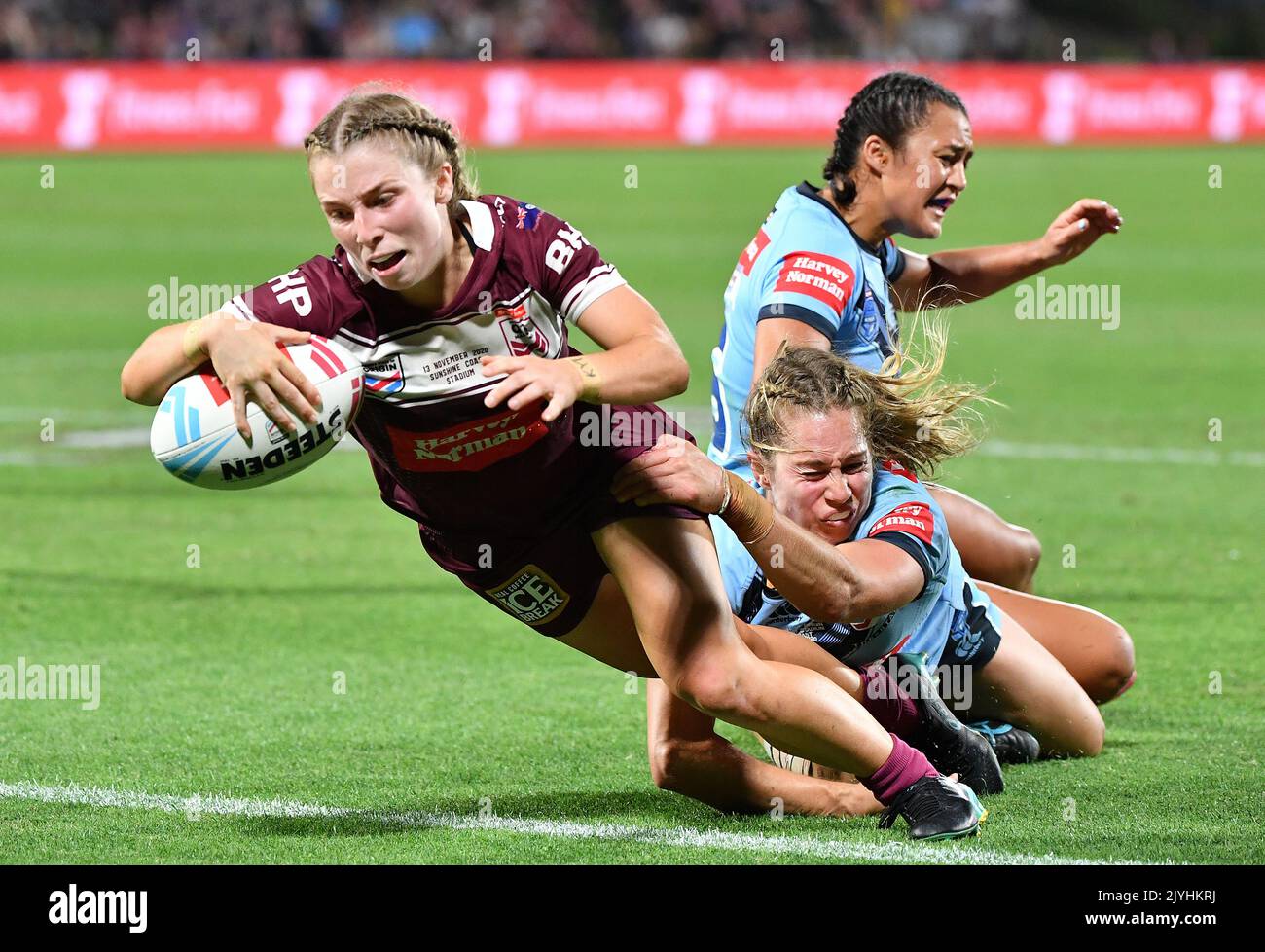 Tarryn Aiken (left) of the Maroons scores a try during the Women's ...
