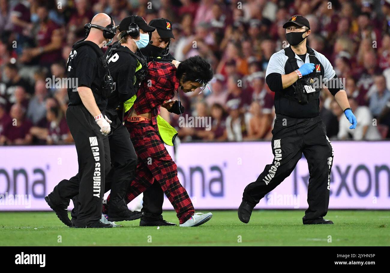 A pitch invader (centre) is seen being taken from the field during Game ...