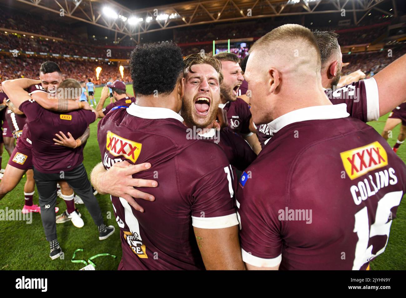 Cameron Munster of the Maroons (centre) celebrates with team mates ...