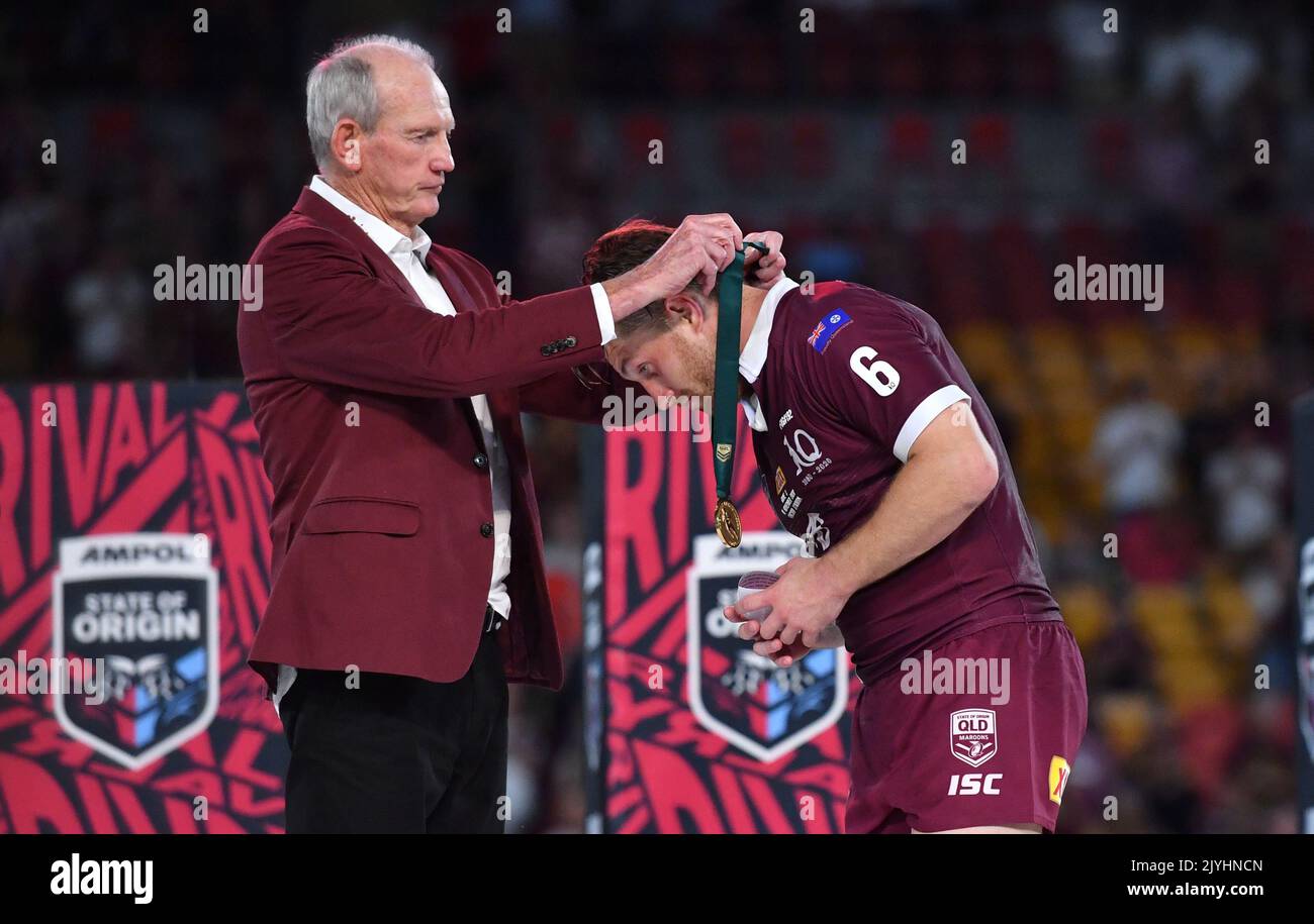 Queensland coach Wayne Bennett (left) is seen presenting Cameron ...