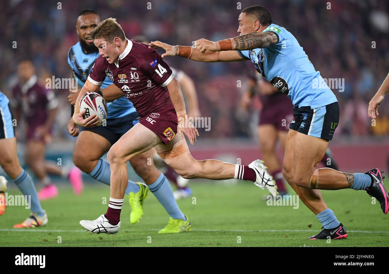 Maroons player Harry Grant evades a tackle by Tyson Frizzell during ...