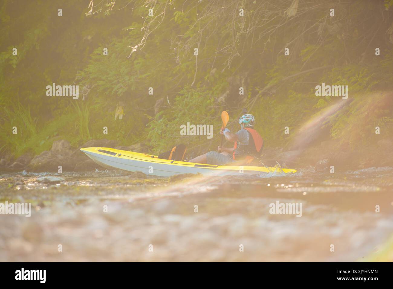 Senior kayaker is kayaking while he is keeping up with his group Stock ...
