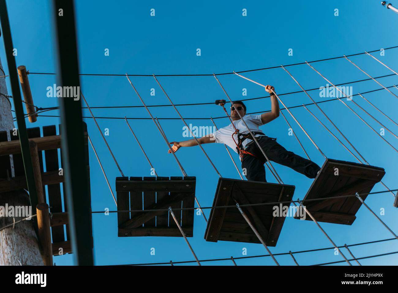 Man handling the hardest rope level with no difficulty in an adventure ...