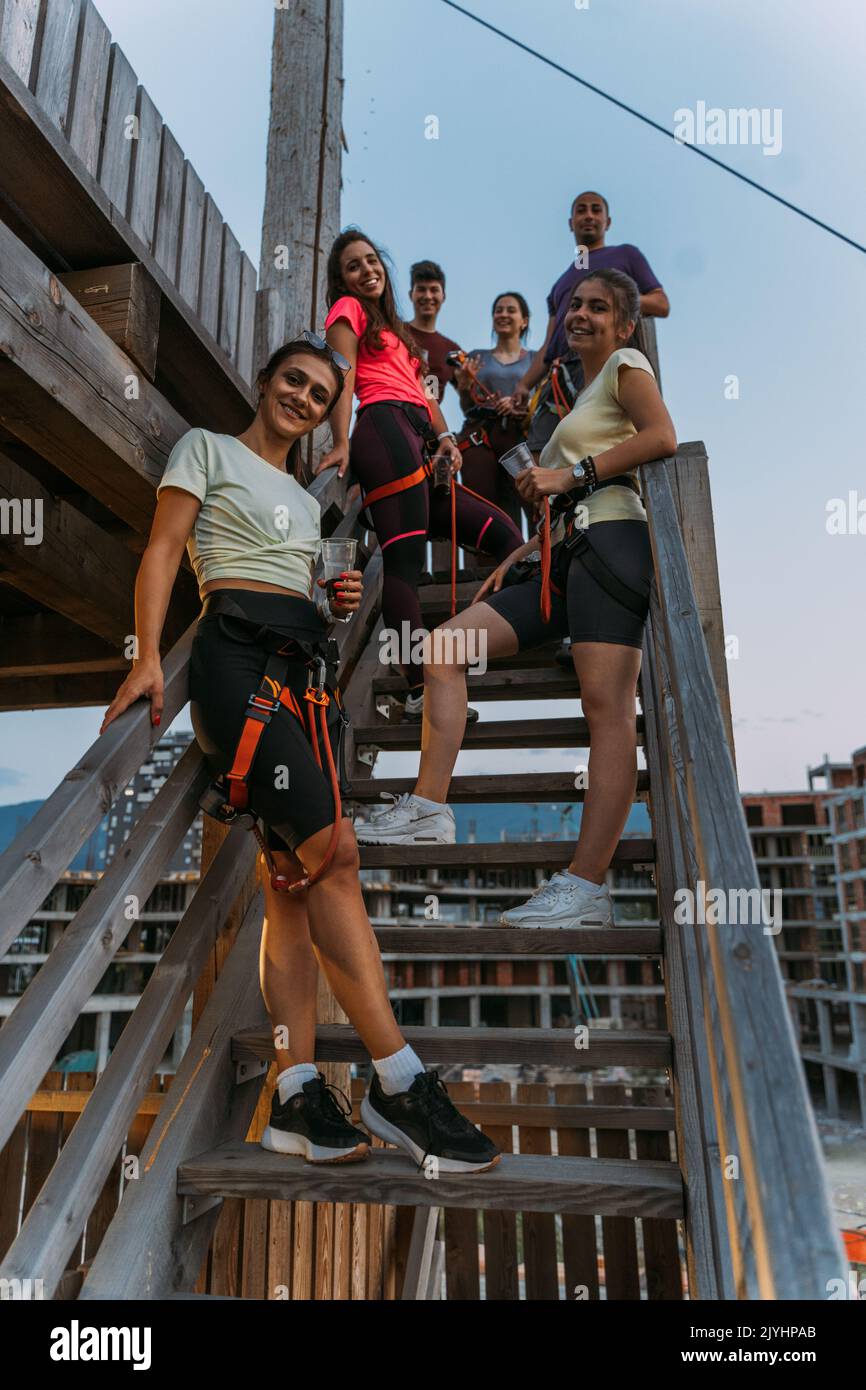 Group of rock climbers taking a photo and laughing whilst staning on ...
