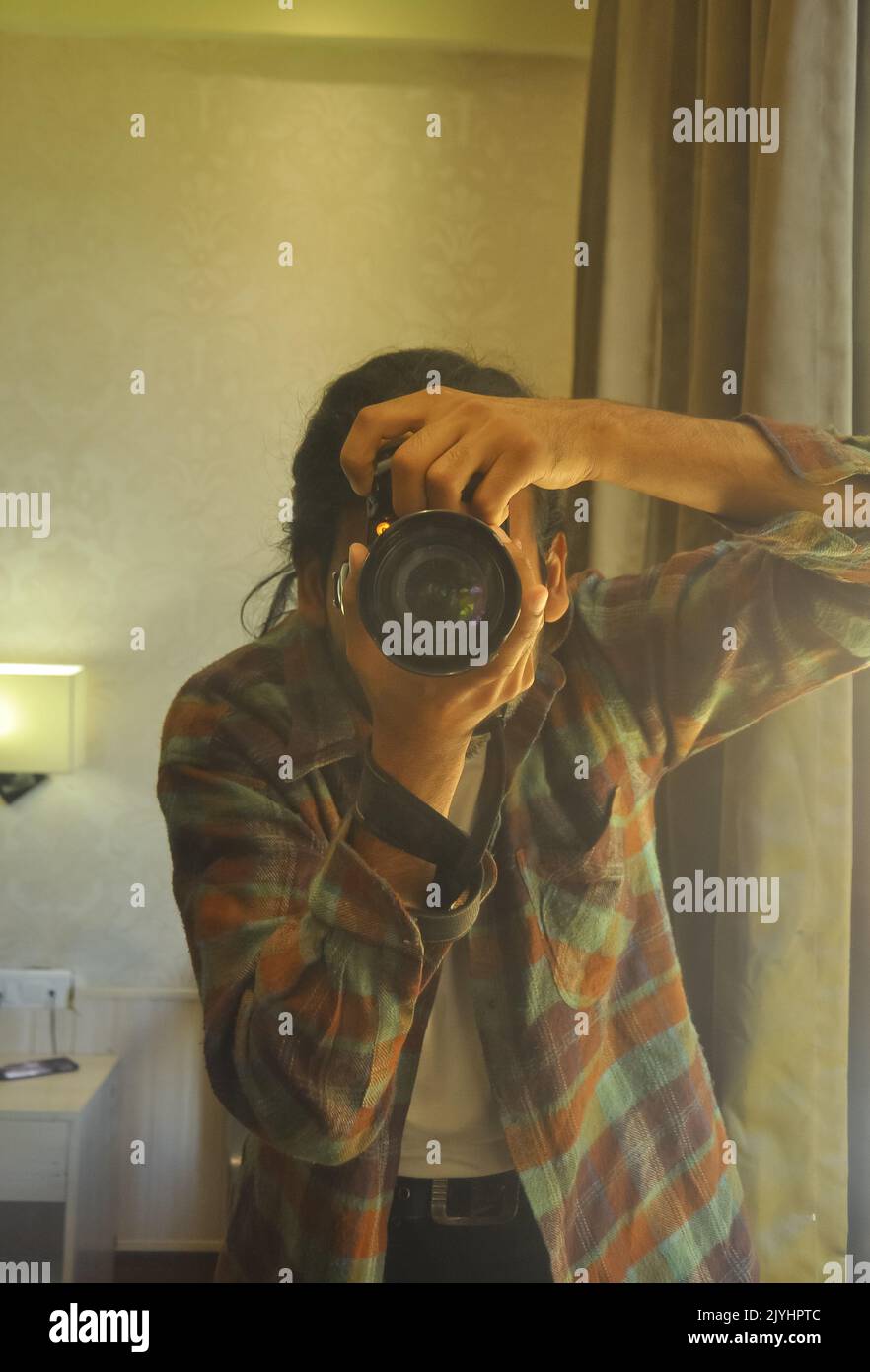 A Male Photographer Taking Selfie With His Dslr Camera In Front Of