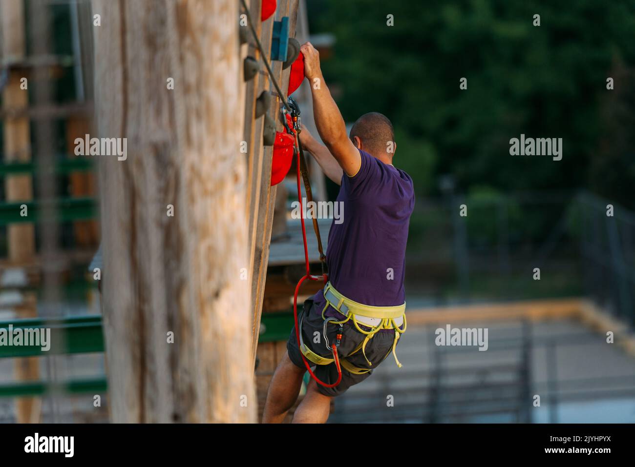 Close up of adventure man from the back climbing at the adventure park ...
