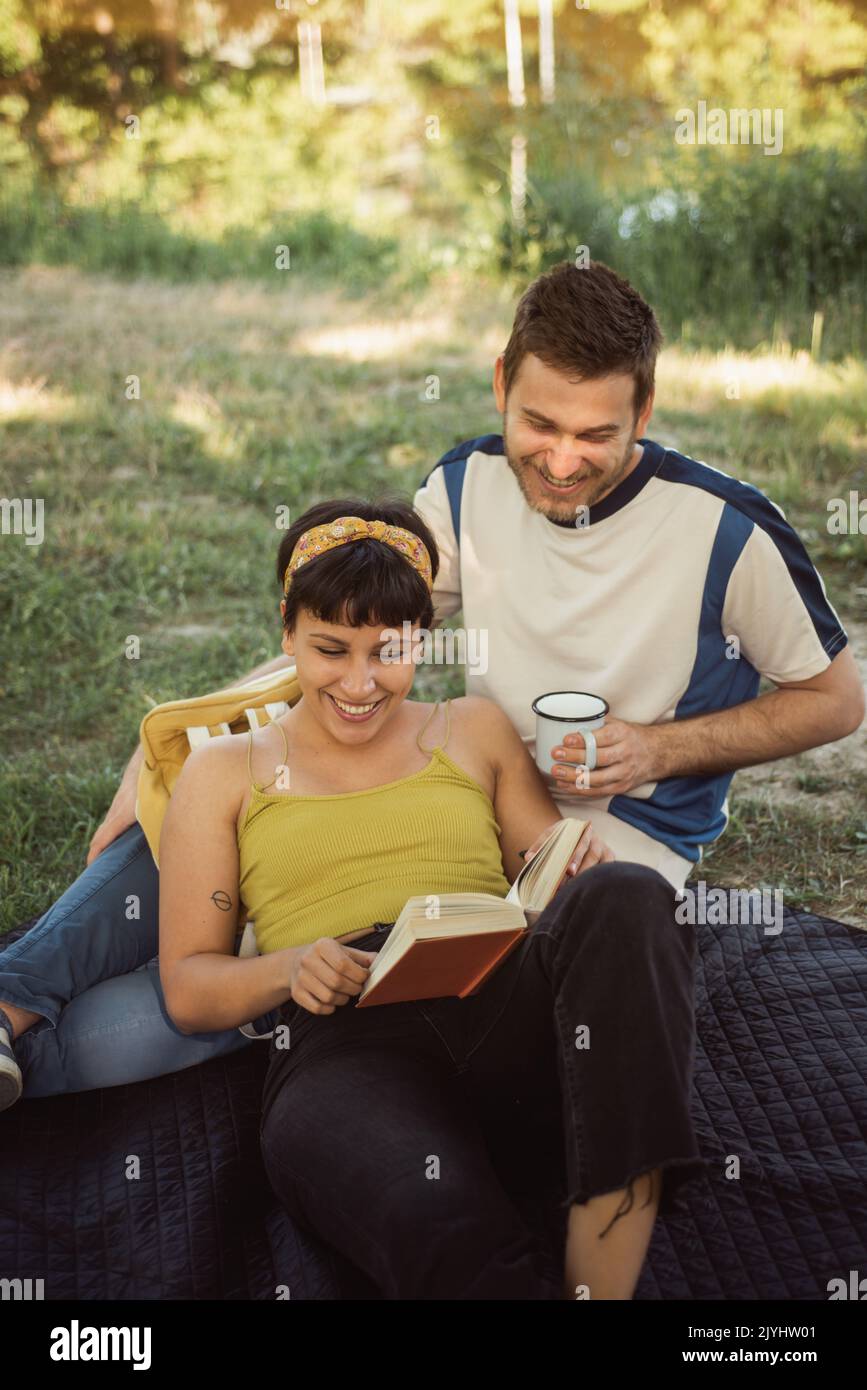 Amazing couple reading together in the park on the picinc Stock Photo ...