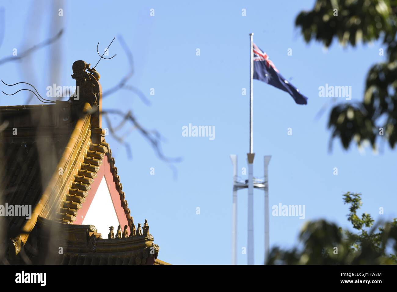 The flagpole of the Australian Parliament House is seen behind the roof ...