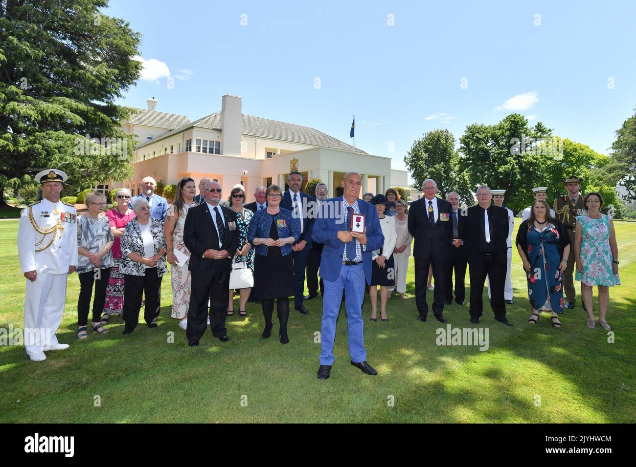 Officials, family gather as Garry Ivory (C), nephew of Ordinary Seaman ...