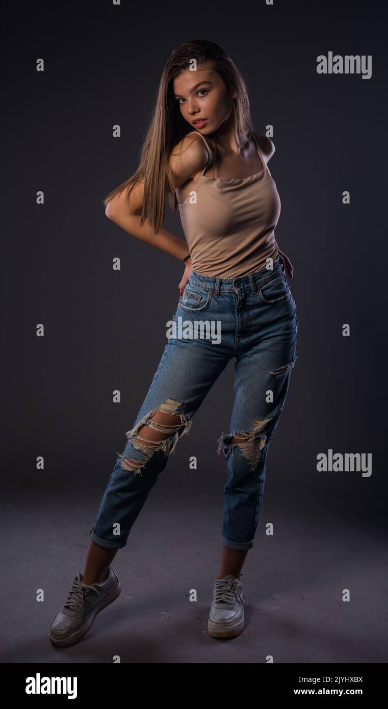 Portrait of a beautiful stylish girl posing in trendy modern clothes ...