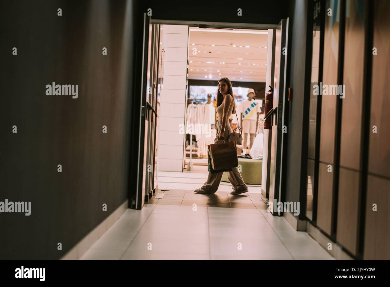 Teenage cute girl with her shopping bags walking in the mall Stock ...
