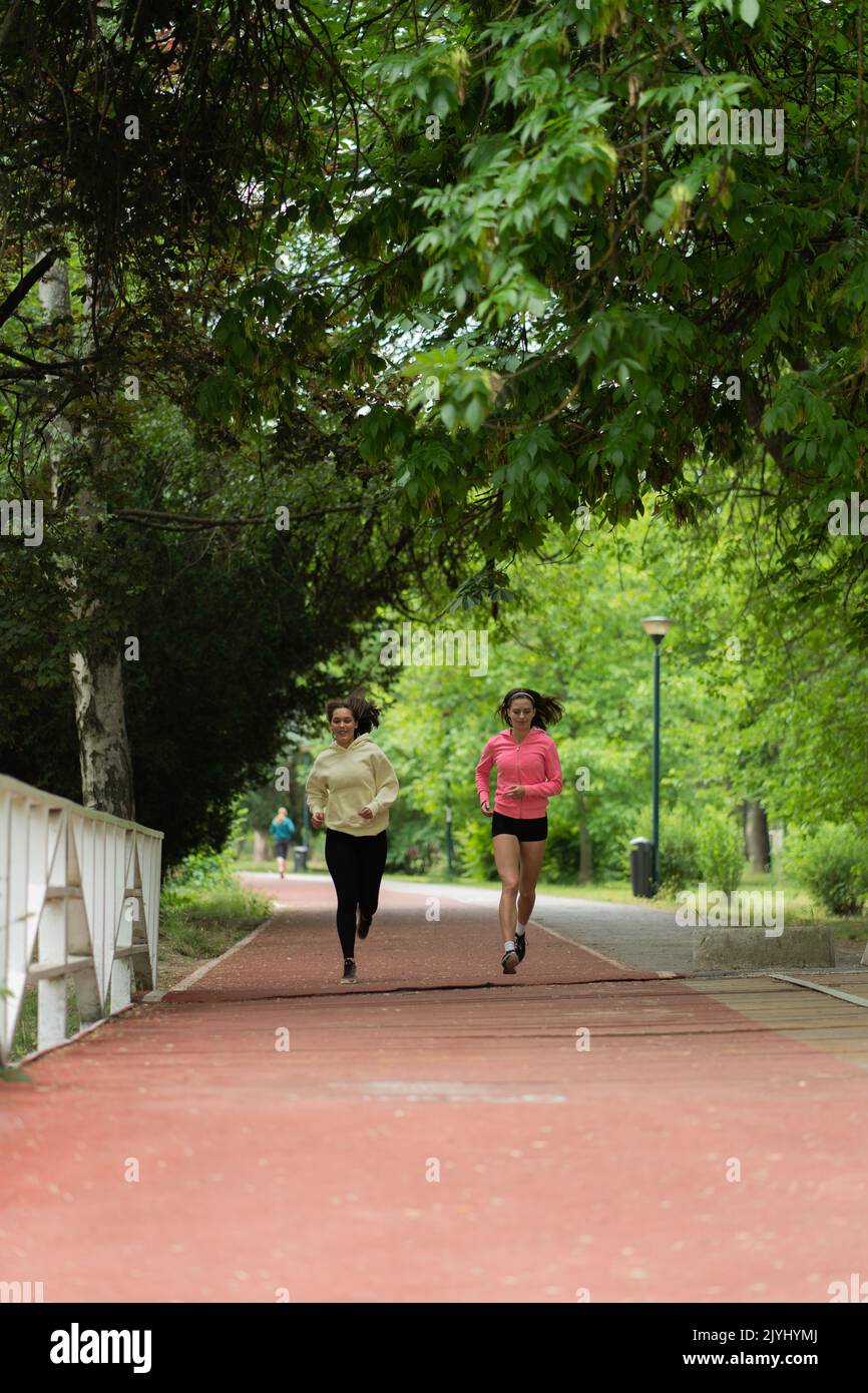 Two girls are doing their running routine in the morning Stock Photo ...