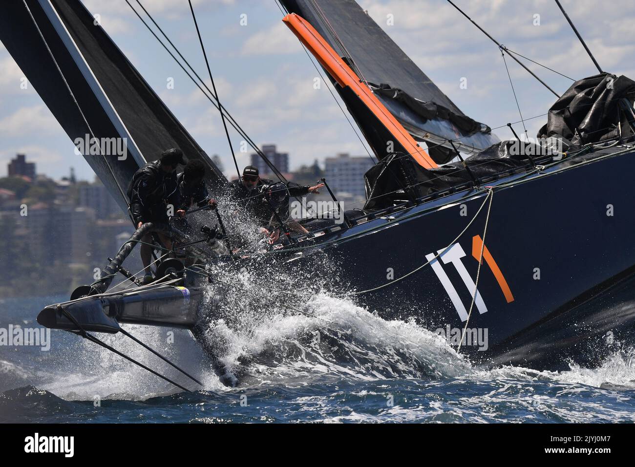 Crew onboard the Super Maxi InfoTrack prepare a sail during the annual ...