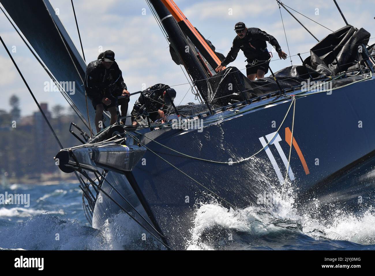 Crew onboard the Super Maxi InfoTrack prepare a sail during the annual ...