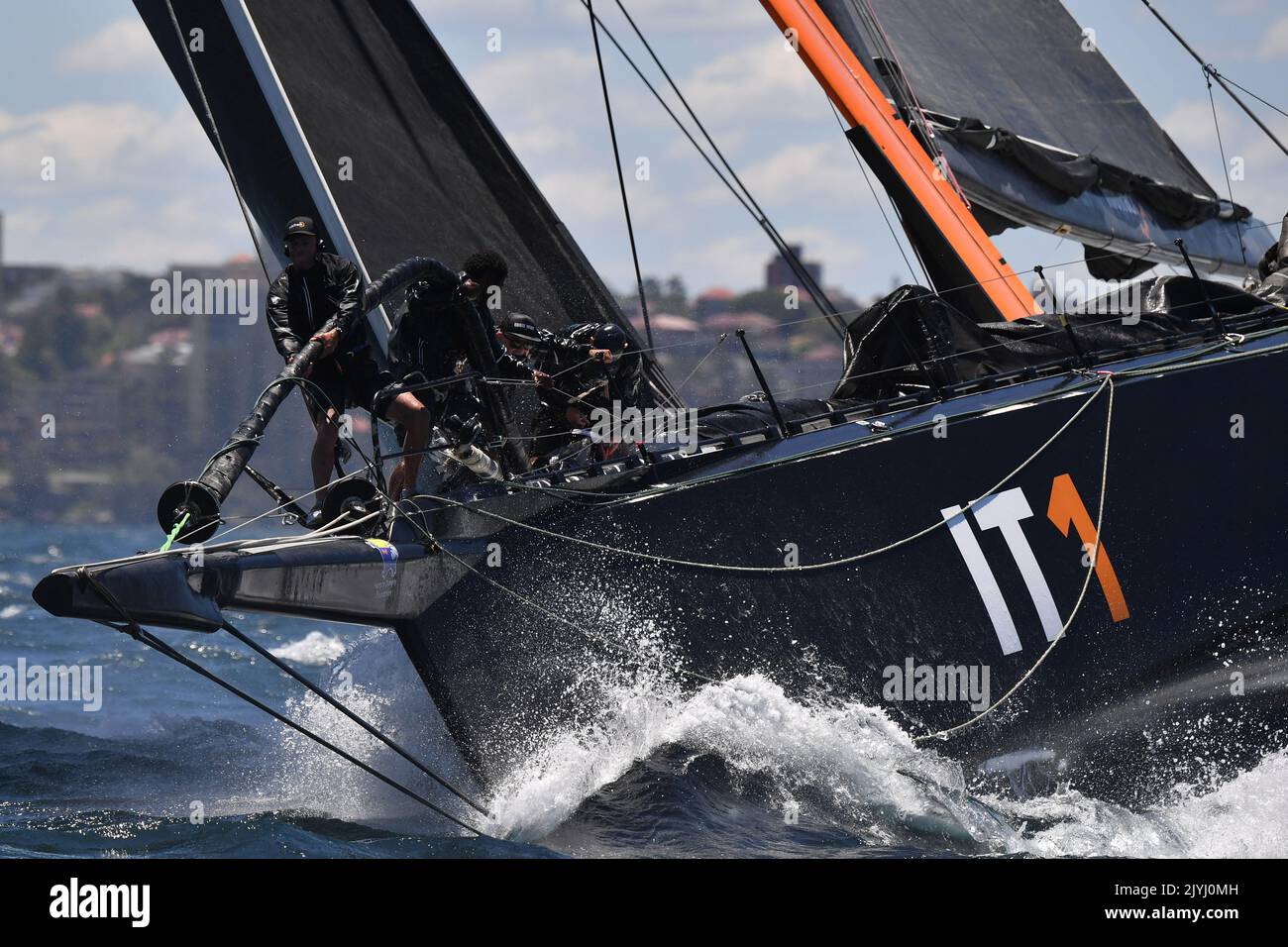 Crew onboard the Super Maxi InfoTrack prepare a sail during the annual ...