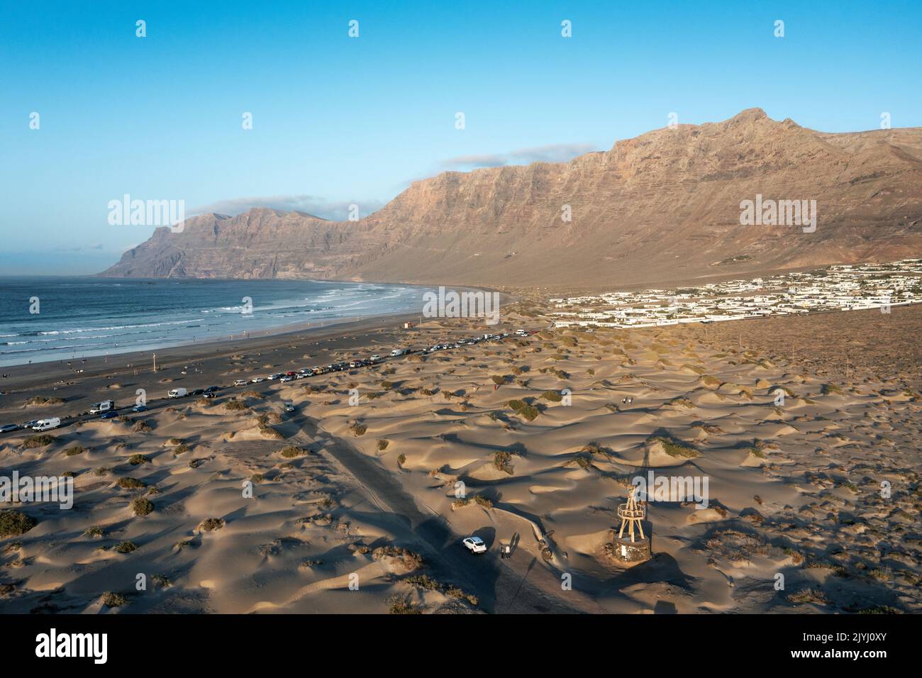 Dunes at the bay Bahia de Penedo and massif Risco de Famara, aerial ...