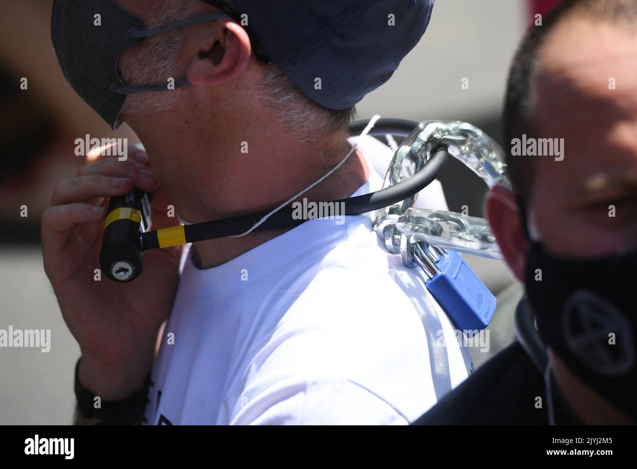 Locks and chains are seen around the necks of protesters during an ...