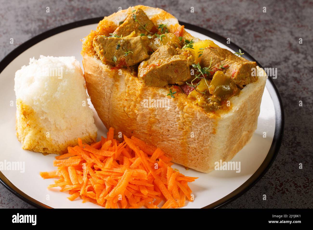 South African cuisine Bunny chow mutton curry in a hollowed out half a ...