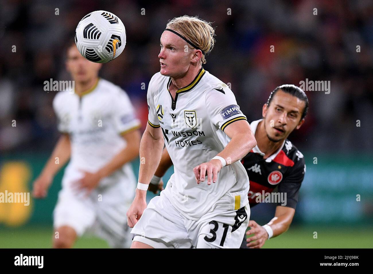 Lachlan Rose of Macarthur competes for possession with Daniel ...