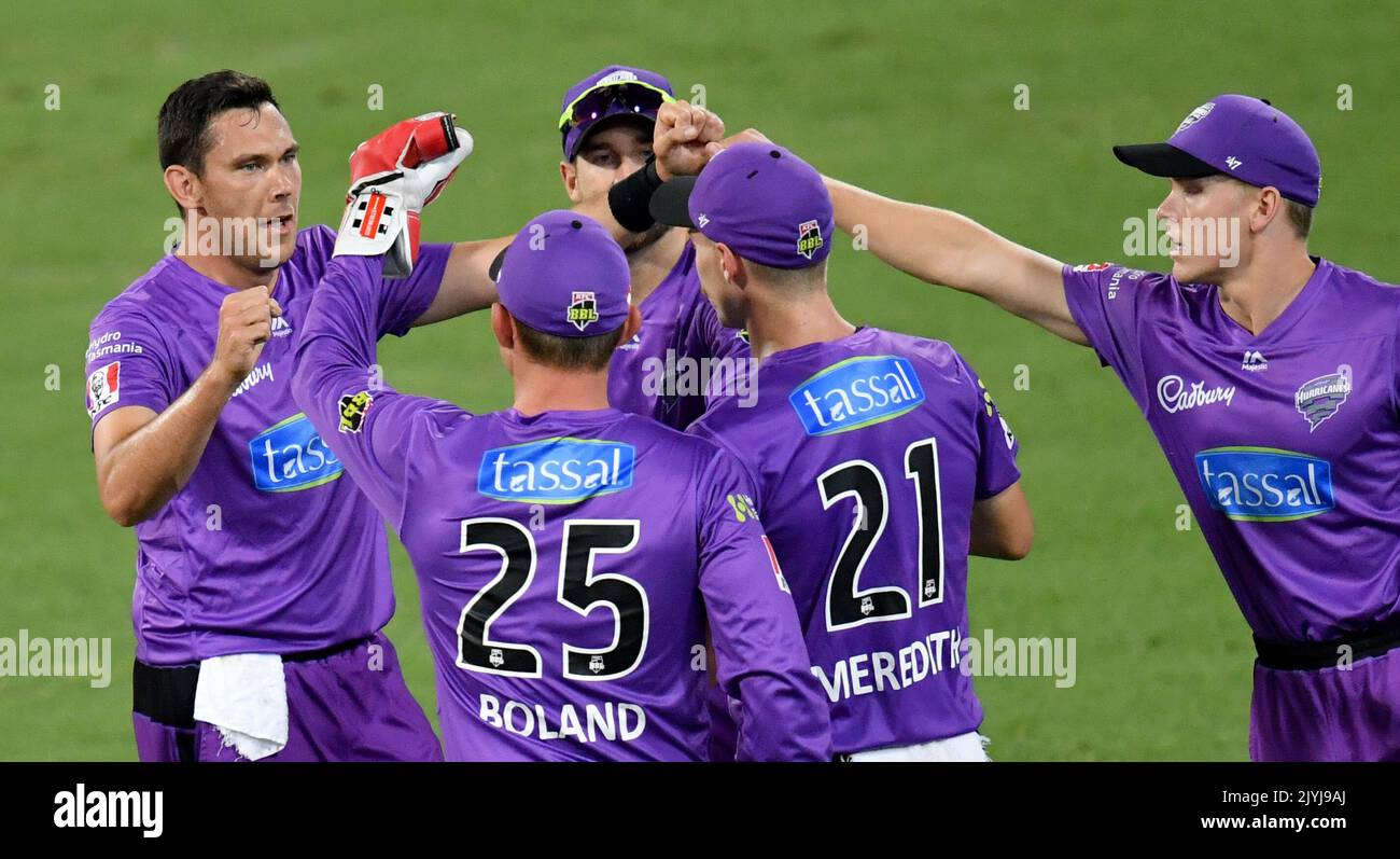 Scott Boland (left) of the Hurricanes celebrates with team mates after ...