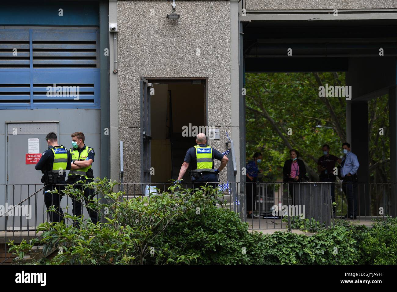 Victoria Police are seen at a crime scene outside of a public housing ...