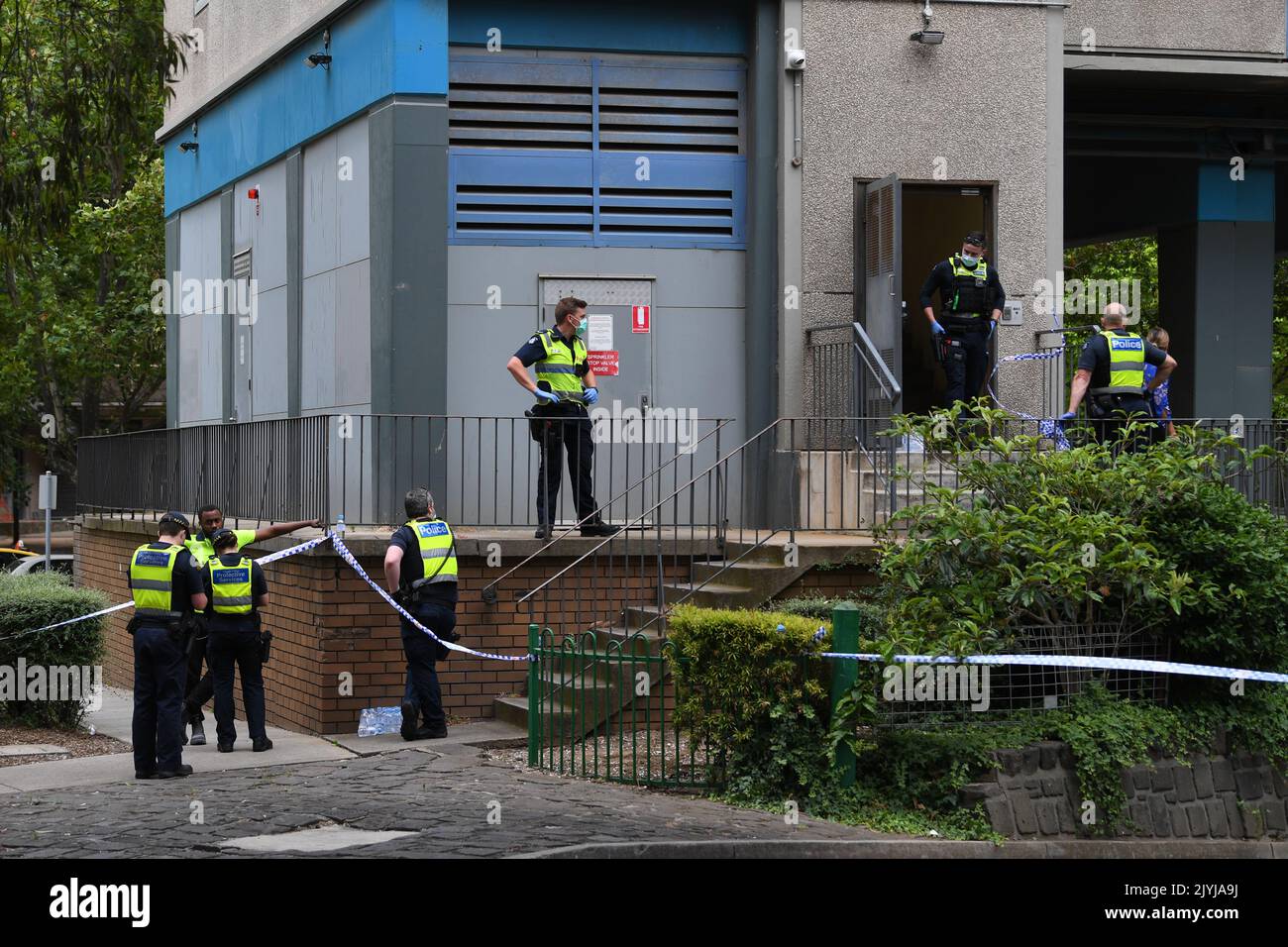Victoria Police are seen at a crime scene outside of a public housing ...