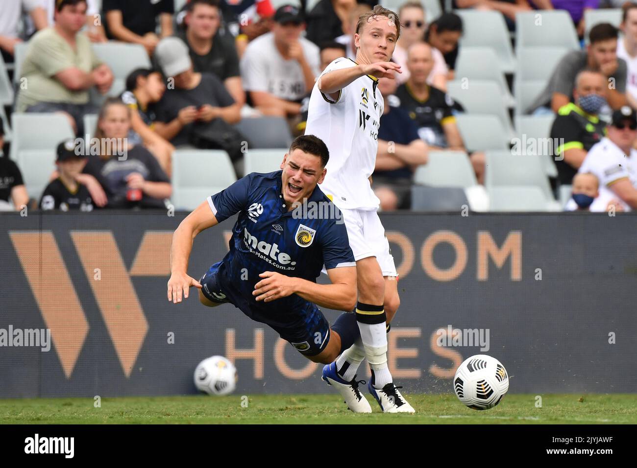 Lewis Miller of the Mariners is brought down by Jake Hollman of ...